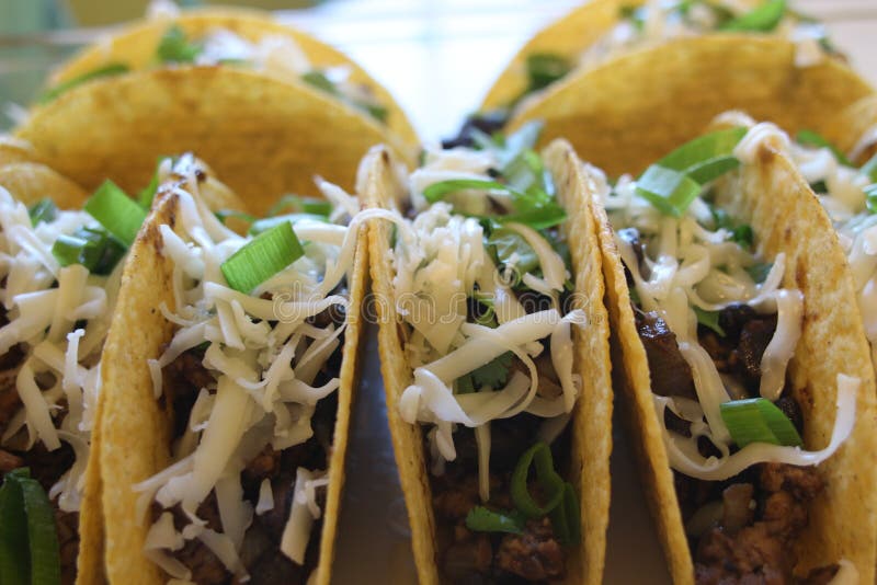 Three Beef Tacos with Cheese, Lettuce and Tomatoes Stock Image - Image ...