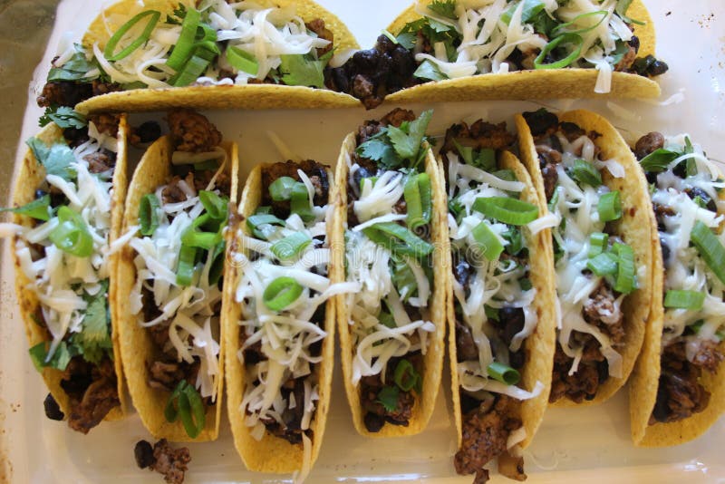 Three Beef Tacos with Cheese, Lettuce and Tomatoes Stock Photo - Image ...