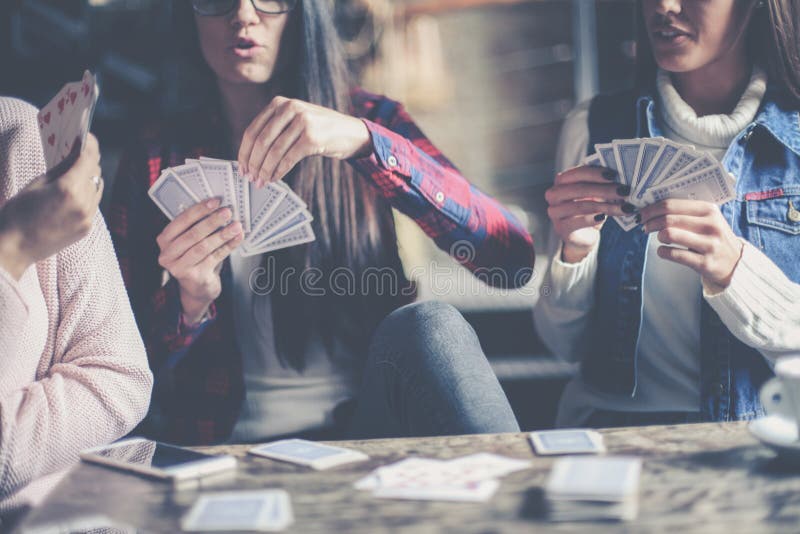 Three Best Friends in Cafe Playing Together Game Cards. Stock Image ...