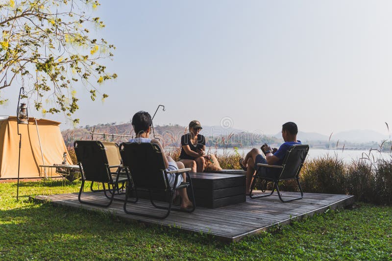 Three Best Friends Sitting at Camping Nature Outdoors Using Mobile ...