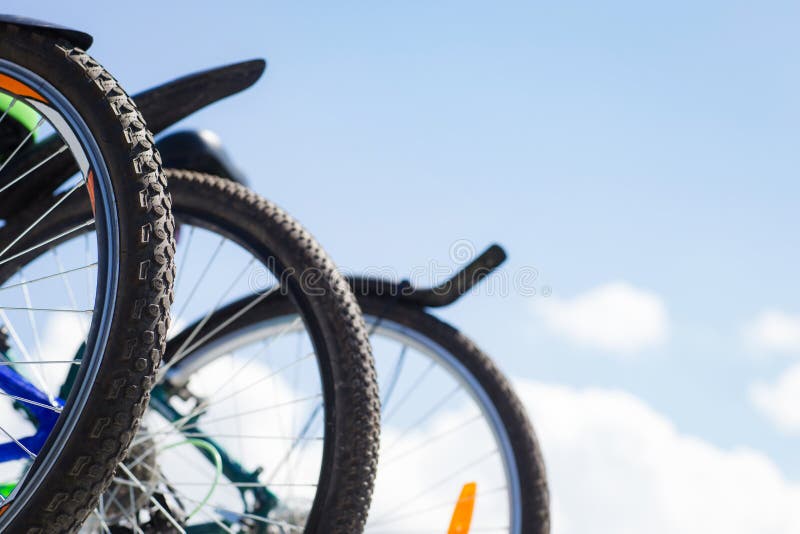 Three Bikes in a Row Against the Blue Sky. Bicycle Ride Stock Photo ...