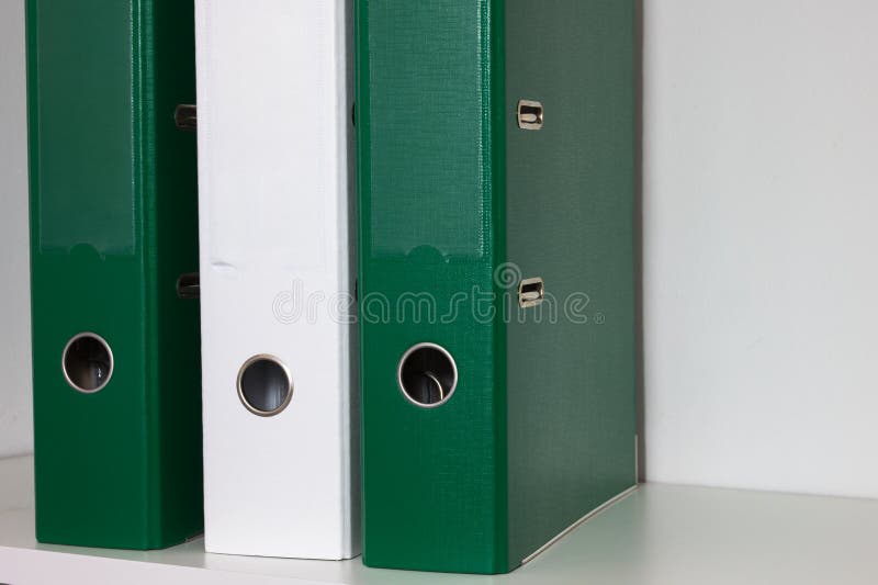 Three binders on the shelf stock image. Image of colorful - 202207293