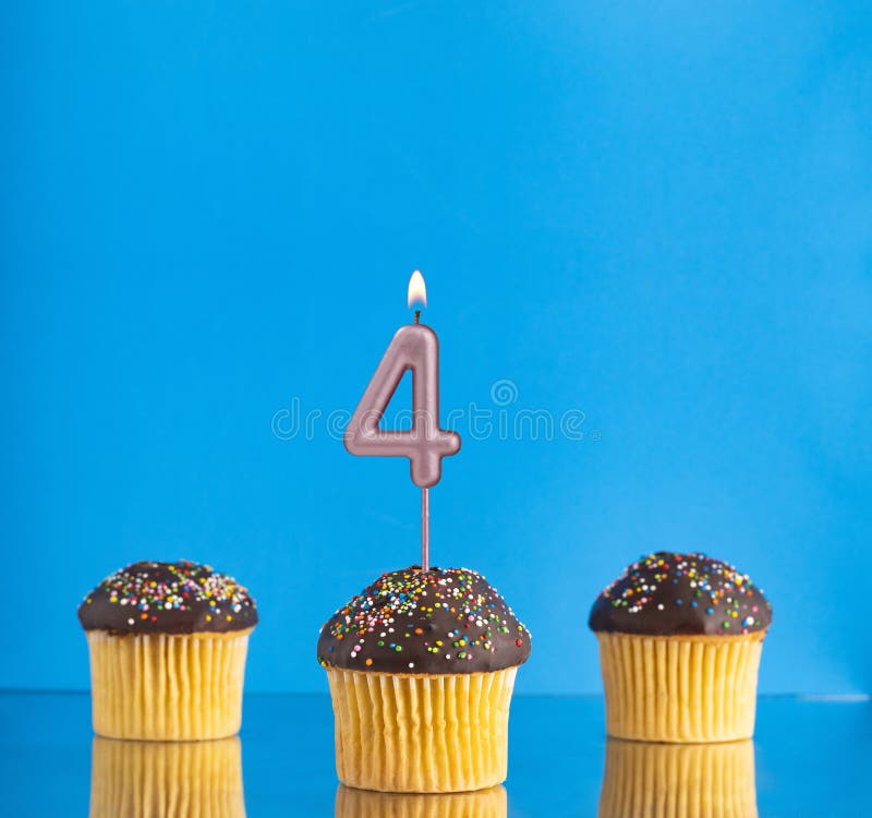 Three Birthday Cupcakes with Number 4 Candle - Blue Background Stock ...