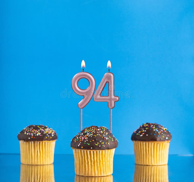 Three Birthday Cupcakes with Number 94 Candle - Blue Background Stock ...