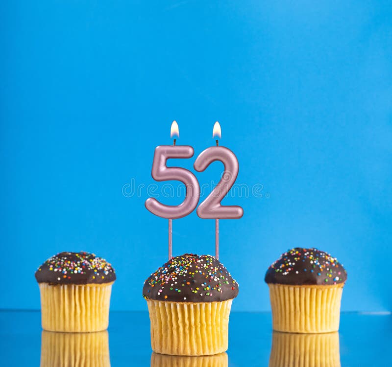 Three Birthday Cupcakes with Number 52 Candle - Blue Background Stock ...