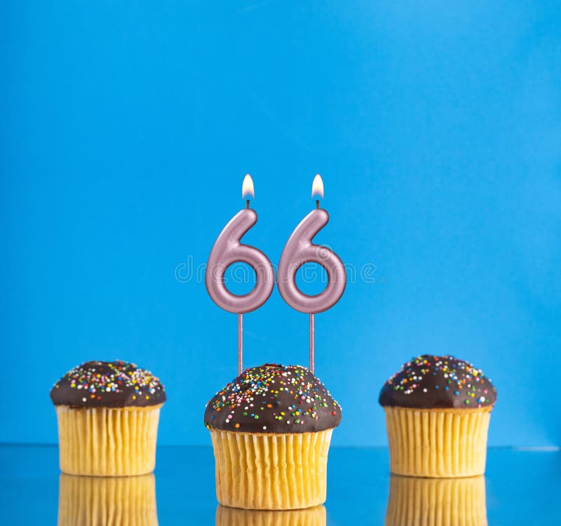 Three Birthday Cupcakes with Number 66 Candle - Blue Background Stock ...