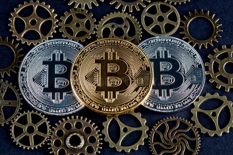 Three Bitcoins among Copper Cog Wheels Closeup. Cryptocurrency Concept ...