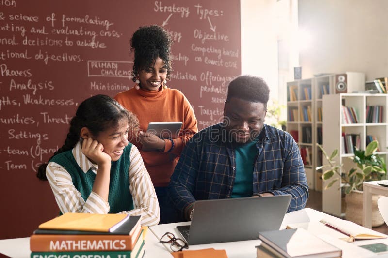 Three Black College Students Looking at Laptop in Class Stock Photo ...