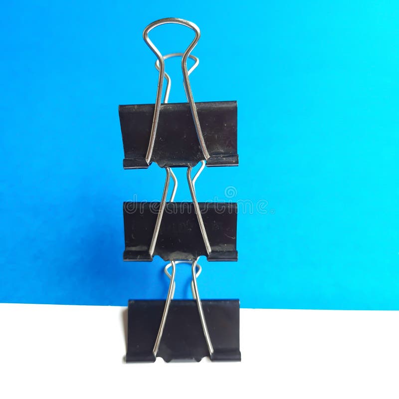 Three Black Paper Clips or Chart Clips Arranged Vertically in White and ...