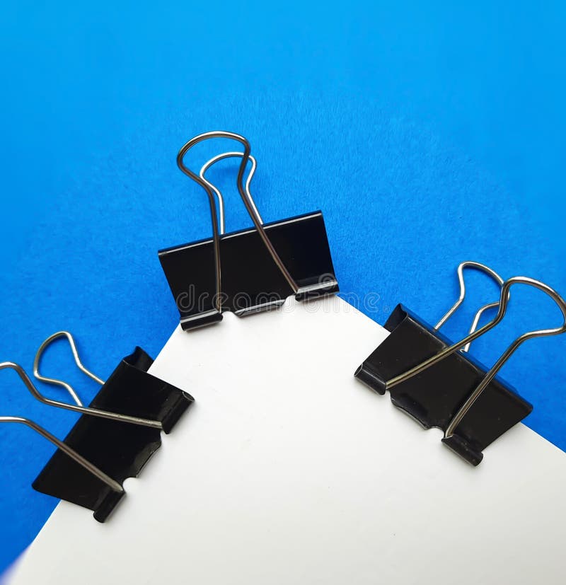 Three Black Paper Clips or Chart Clips Arranged in White and Blue ...