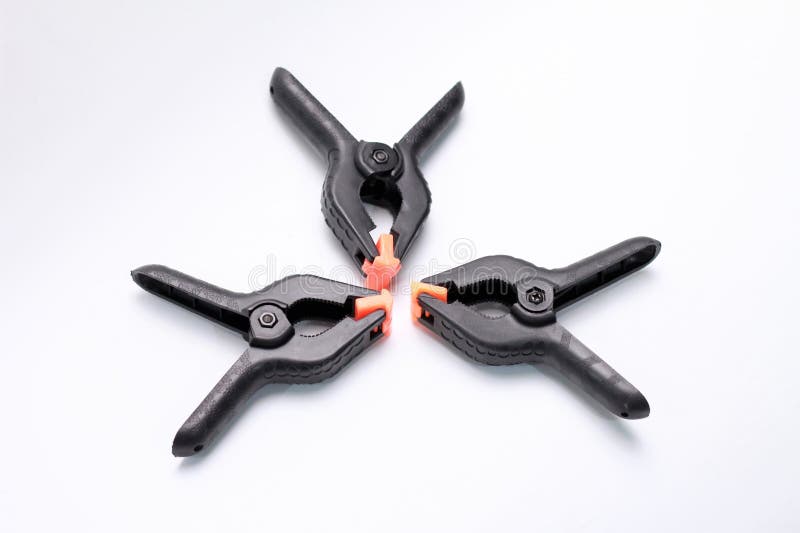 Three Black Plastic Spring Clamps Arranged Differently Stock Photo ...