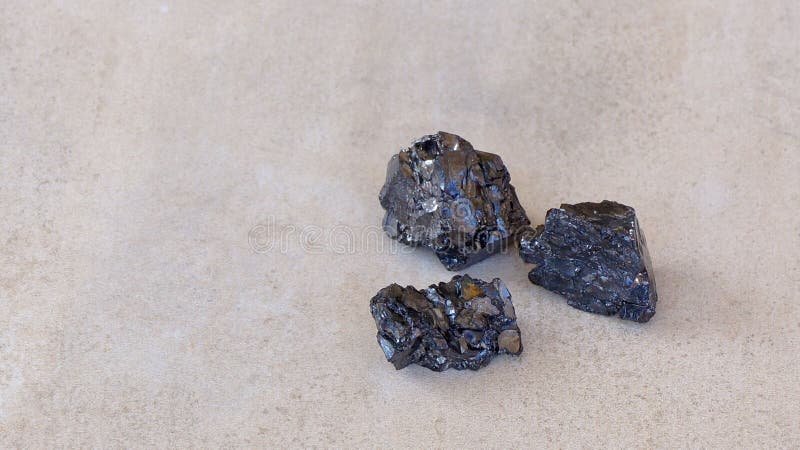 Three Black Shungite Mineral Stones on Natural Background Stock Photo ...
