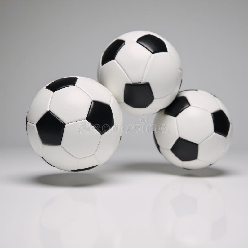 Three Blackandwhite Soccer Balls Arranged Against a Plain Backdrop ...
