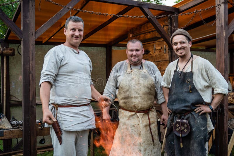 Three Blacksmiths Posing in Front of a Workshop in the Open Air. Stock ...