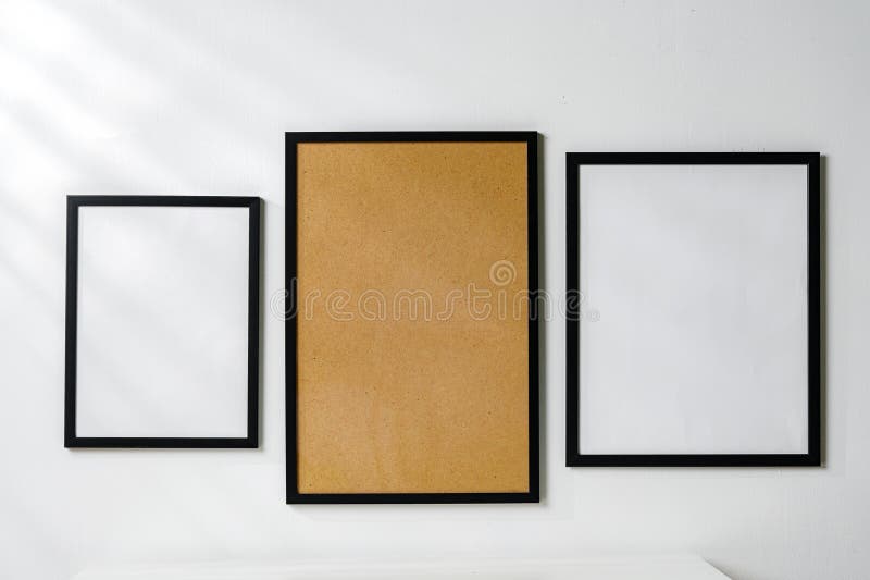 Three Blank Frames with Copy Space Hanging on White Wall Stock Photo ...