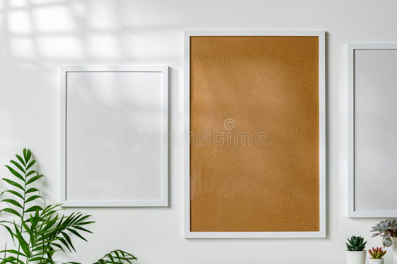 Three Blank Frames with Copy Space Hanging on White Wall Stock Image ...