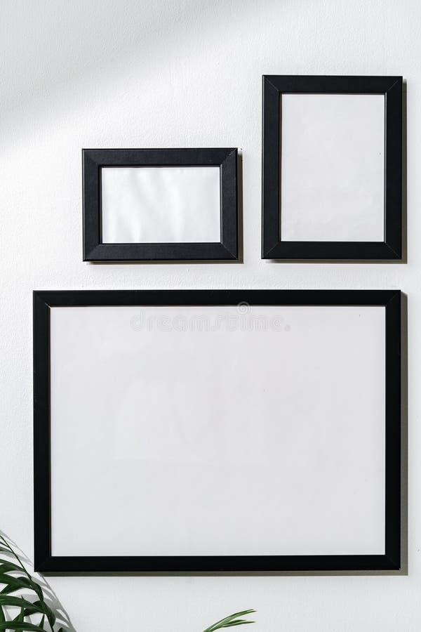 Three Blank Frames with Copy Space Hanging on White Wall Stock Image ...