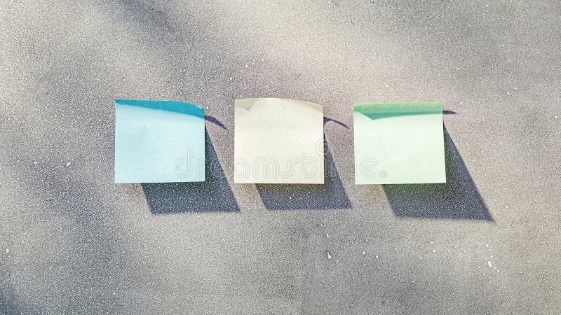 Three Blank Sticky Notes Pinned To a Textured Grey Wall in Natural ...