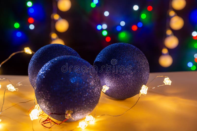 Three Blue Balls and Lights are on the Light Table/background. There ...