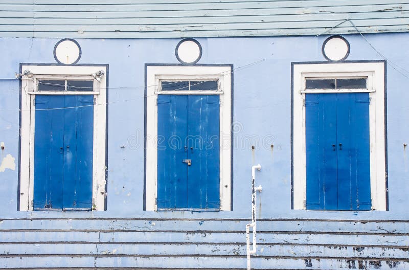 Three Blue Doors on Blue Building Stock Image - Image of stucco ...