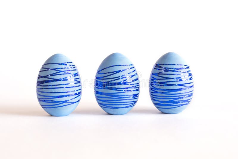 Three Blue Easter Eggs with Blue Shiny Stripes on a White Background ...