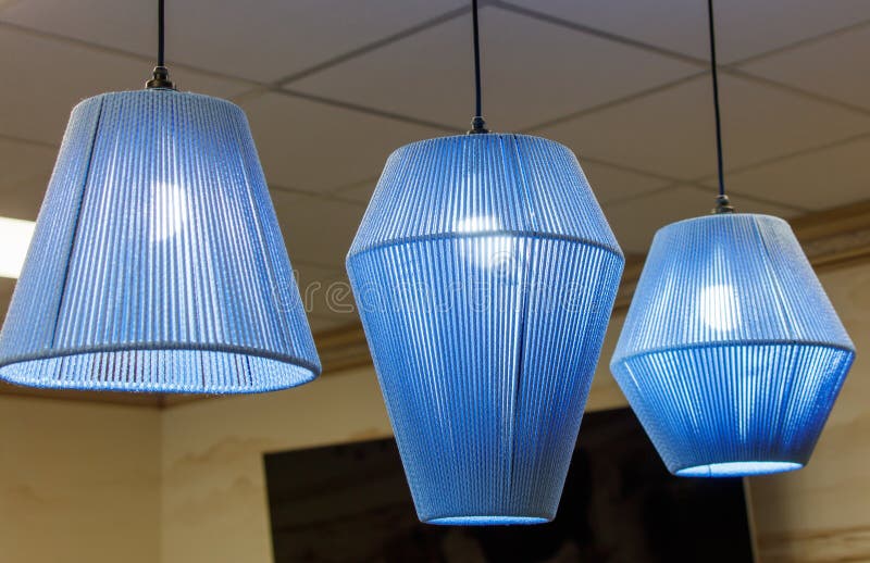Three Blue Lighted Lamps Hanging from the Ceiling Stock Photo - Image ...