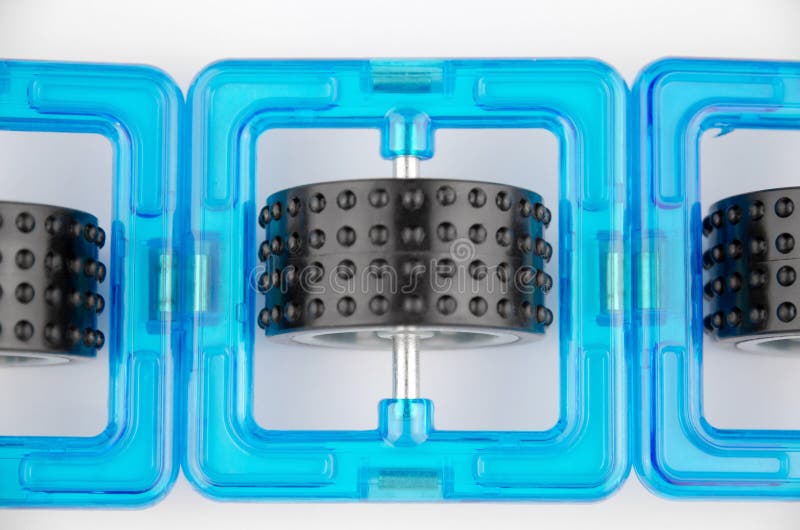 Three Blue Transparent Magnet Squares with Black Wheels Inside Stock ...