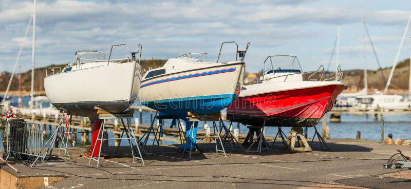 Three Boats on Land Supported by Boat Stands.. Stock Image - Image of ...