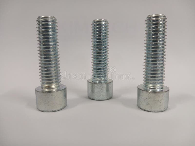 Three Bolts on the White Table Stock Image - Image of industrie, steel ...