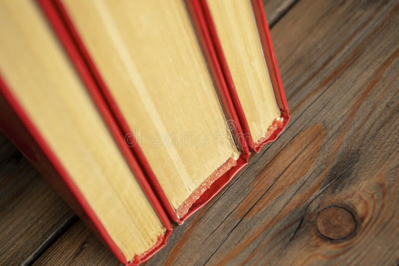 Three Books Stand Side by Side on a Wooden Table. the Spines of Books ...