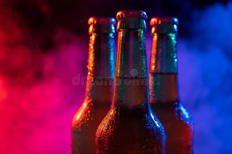 Three Bottles of Beer in a Blue-pink Mist. Stock Image - Image of ...