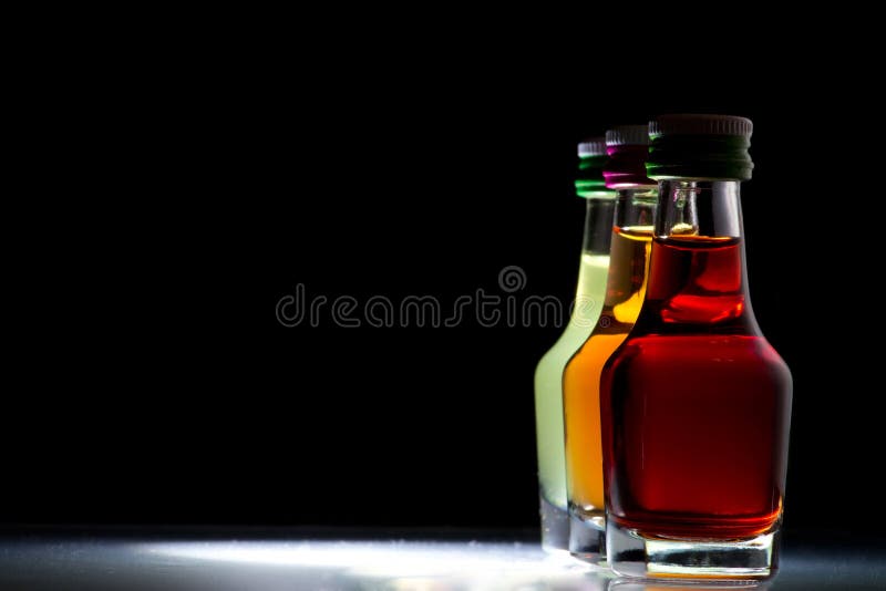 Three bottles with liqueur stock image. Image of black - 25105105