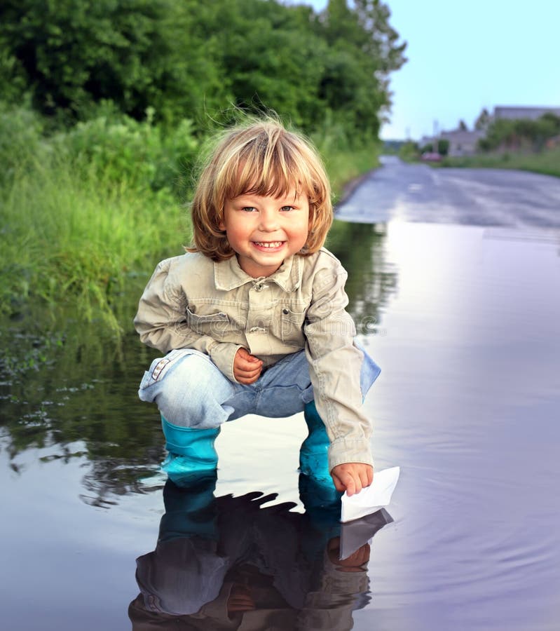 Three boy play in puddle stock image. Image of outdoors - 50928963