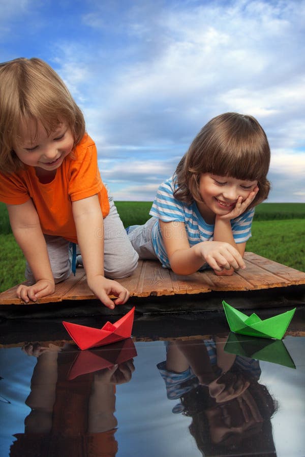 Three boy play in puddle stock image. Image of outdoors - 67800855