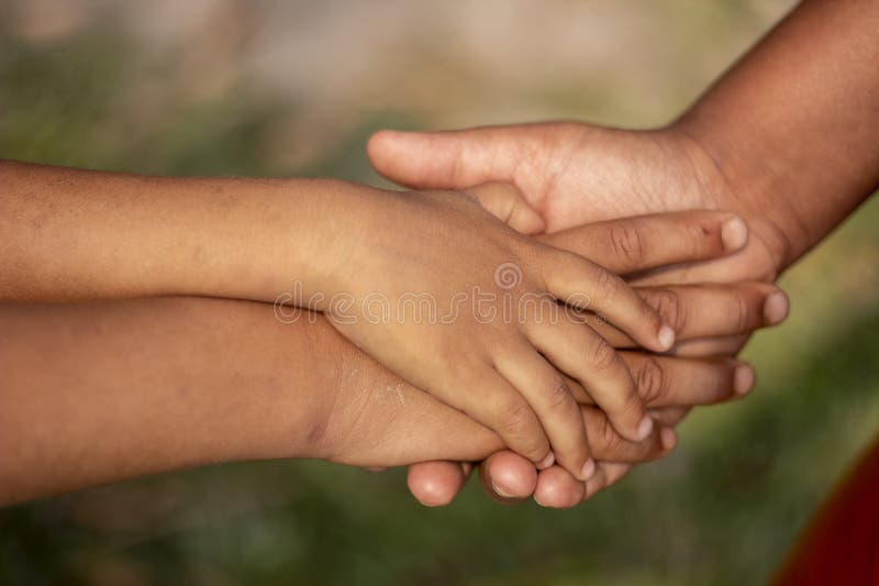 Three Boys Join Hands Together and Put Their Hands on Each Other To ...