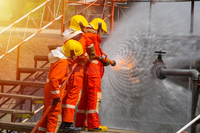 Three Brave Firefighters Using Extinguisher and Water from Hose for ...