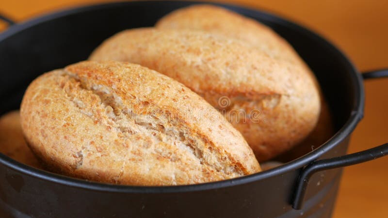 Three Bread Rolls Rest in a Black Bowl on the Table Stock Footage ...