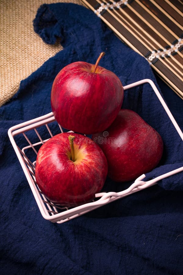 Three Bright Red Apples on a Blue Cloth Stock Image - Image of juicy ...