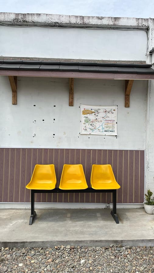 Three Bright Yellow Plastic Chairs are Neatly Arranged on a Black Iron ...