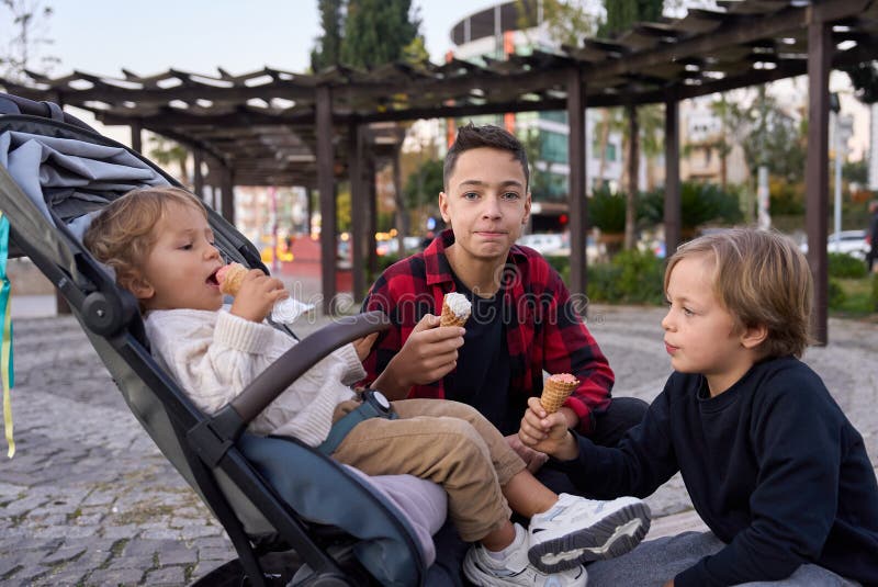 Three Brothers Boys with Ice Cream in City Park. Stock Photo - Image of ...