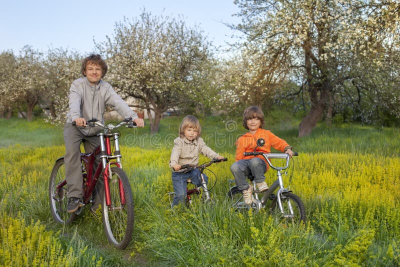 Three brothers ride bikes stock image. Image of child - 65294959