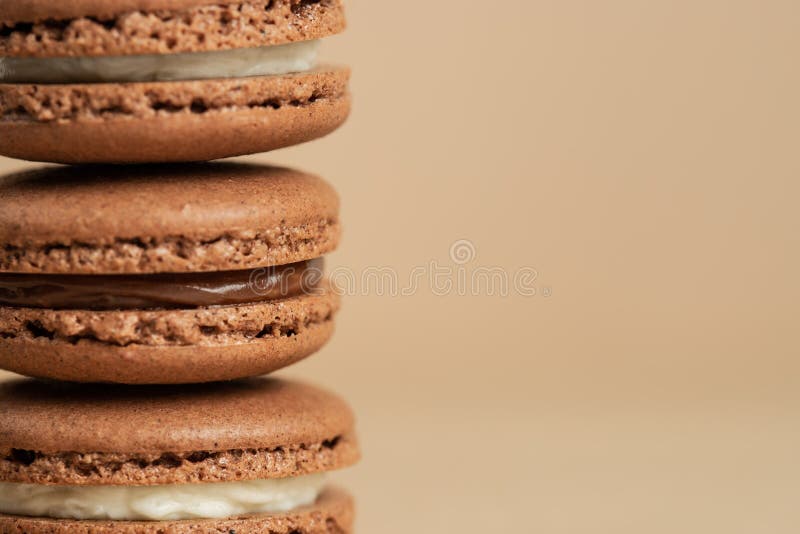 Three Brown Macaron on a Brown Bacgkround Stock Photo - Image of food ...