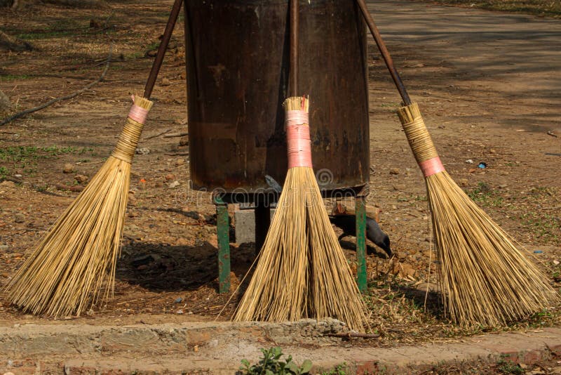 Three Brooms Around a Dustbin in a Park Stock Image - Image of three ...