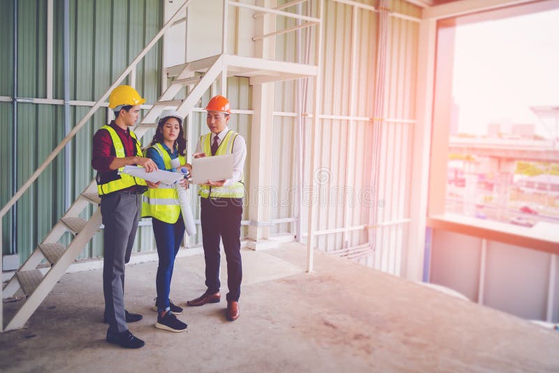 Three Building Contractor, Engineer Construction Worker is Disccusing ...