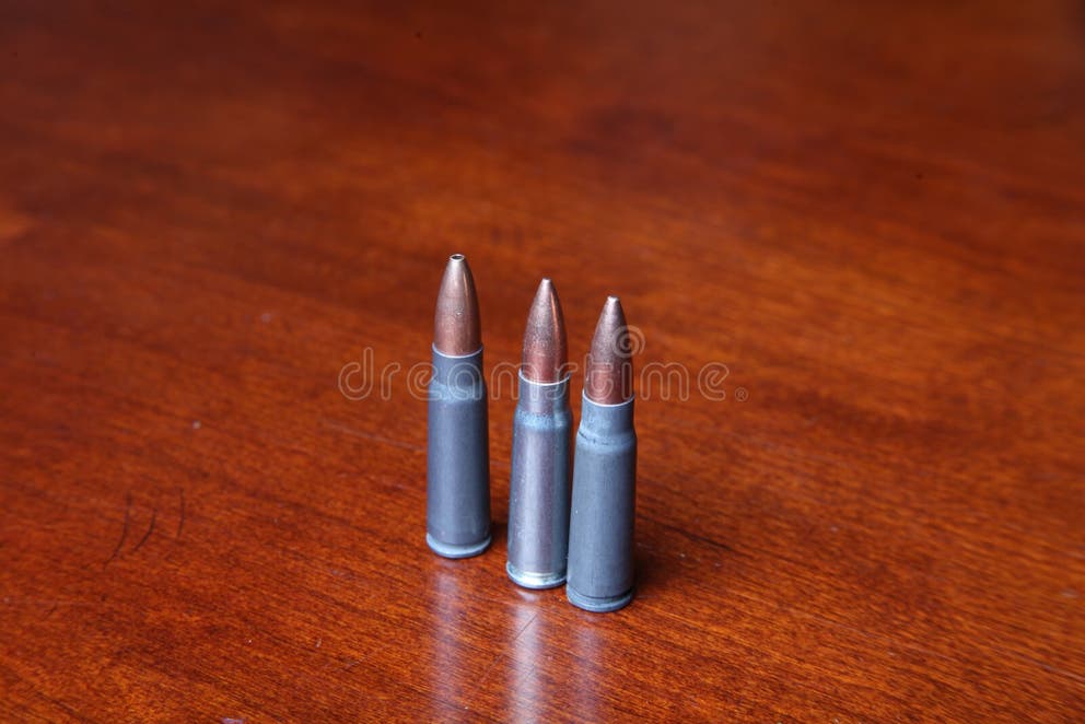 Three bullets stock photo. Image of bullets, table, wood - 52853456