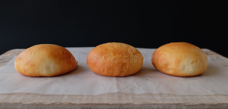 Three Burger Buns on Wood stock image. Image of perspective - 236233175