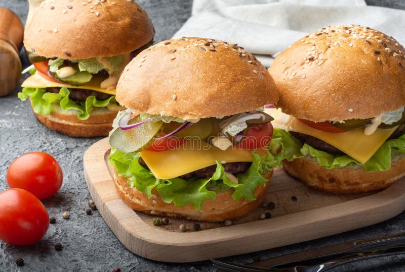 Three Burgers. Burgers on a Wooden Board Stock Image - Image of gourmet ...