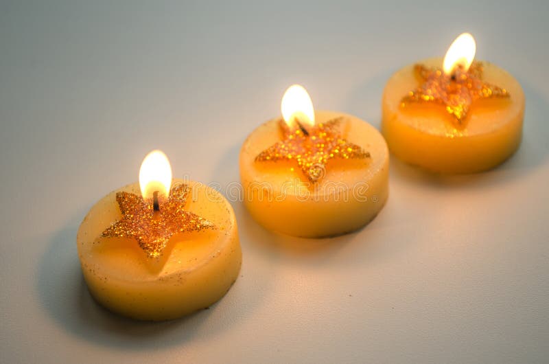 Three Burning Decorative Candles with Star Pattern Stock Image - Image ...
