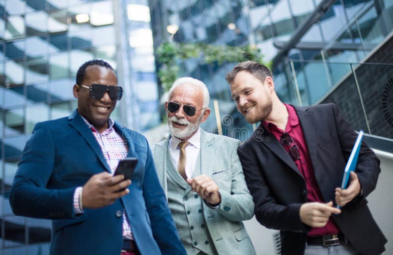 Three Business Men Walking and Talking Outside. Stock Photo - Image of ...