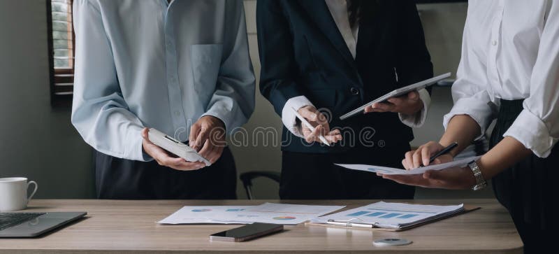 Three Business People with Busy Meetings in the Office. on the Table ...